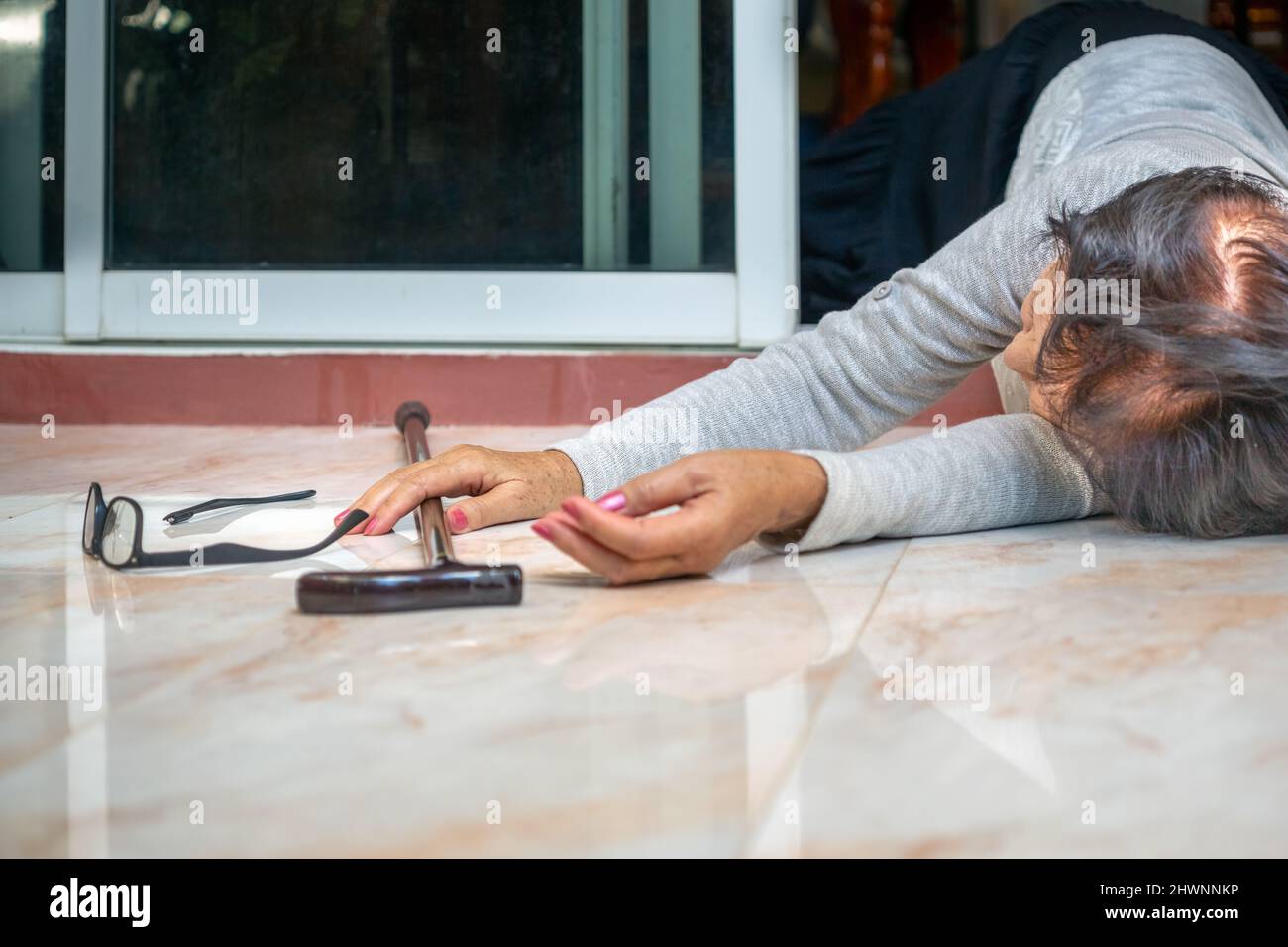 Senior woman falling down at home because stumbled on a door kerb Stock ...