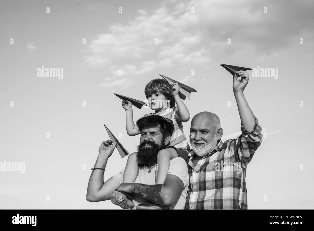 Three different generations ages: grandfather father and child son ...