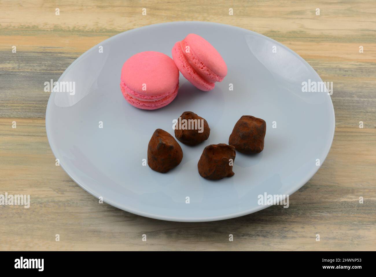 Raspberry macaron flavored truffles with raspberry macarons on blue ...