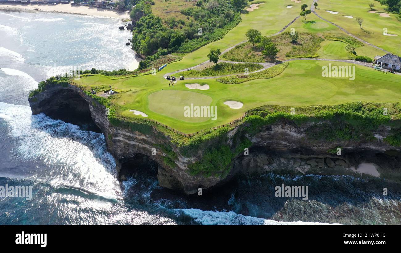 Aerial shot of beautiful golf course on overgrown rocky cliff top in ...