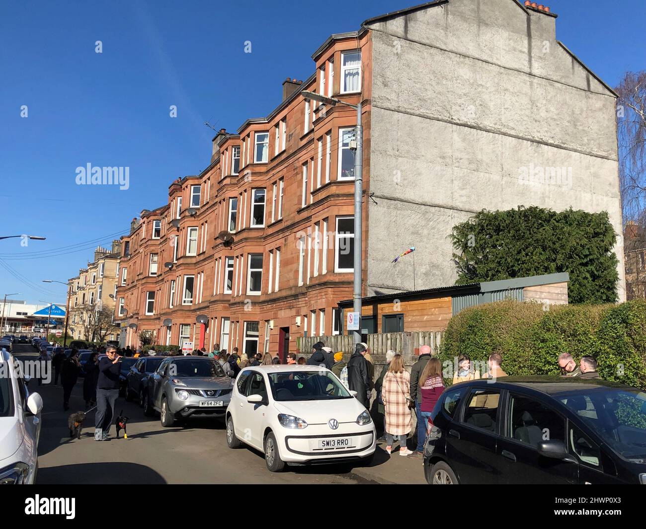 People queue around the block to buy cakes, buns and other baked treats ...