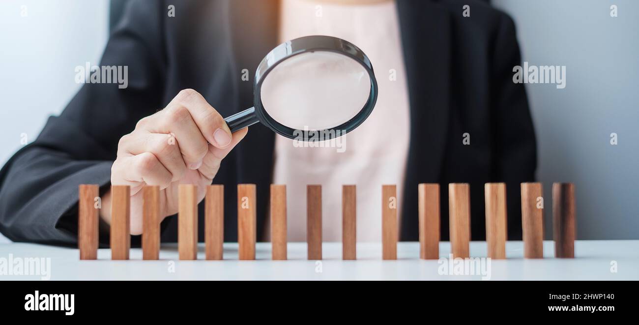 Businesswoman hand holding magnifying glass for recruiting leader man ...