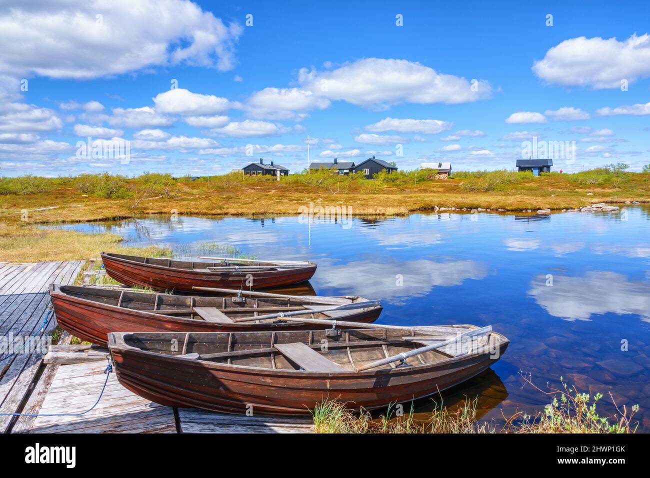 Idyllic landscape view with row boats at a mountain huts jetty Stock ...