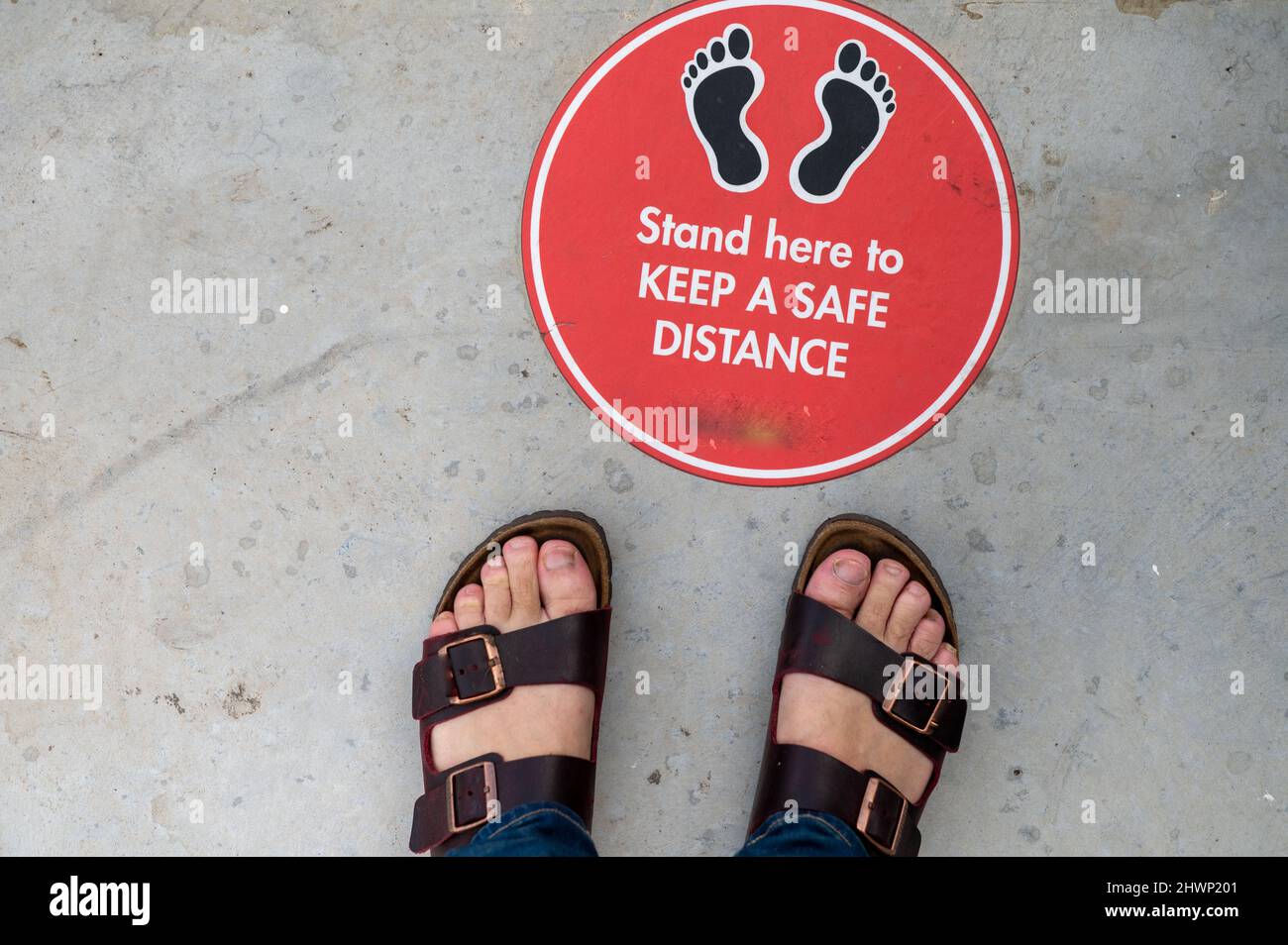 High angle view of person standing next to social distance sign Stock ...