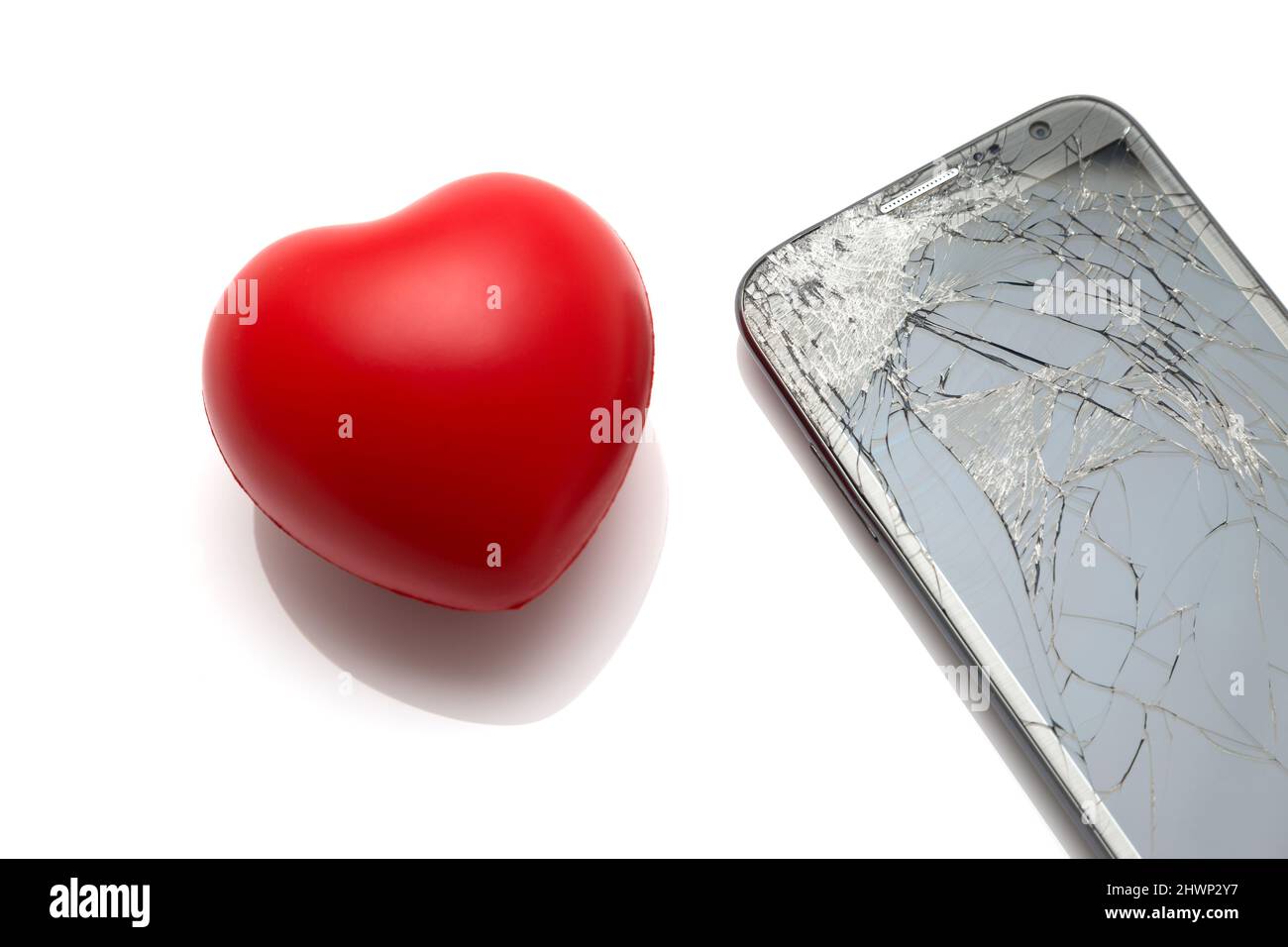 Smartphone with broken screen with red heart isolated on white ...