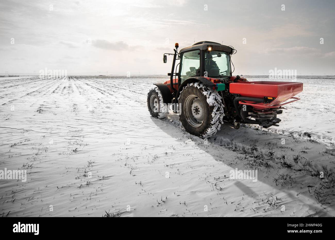 Farmer with tractor seeding - sowing crops at agricultural fields in ...