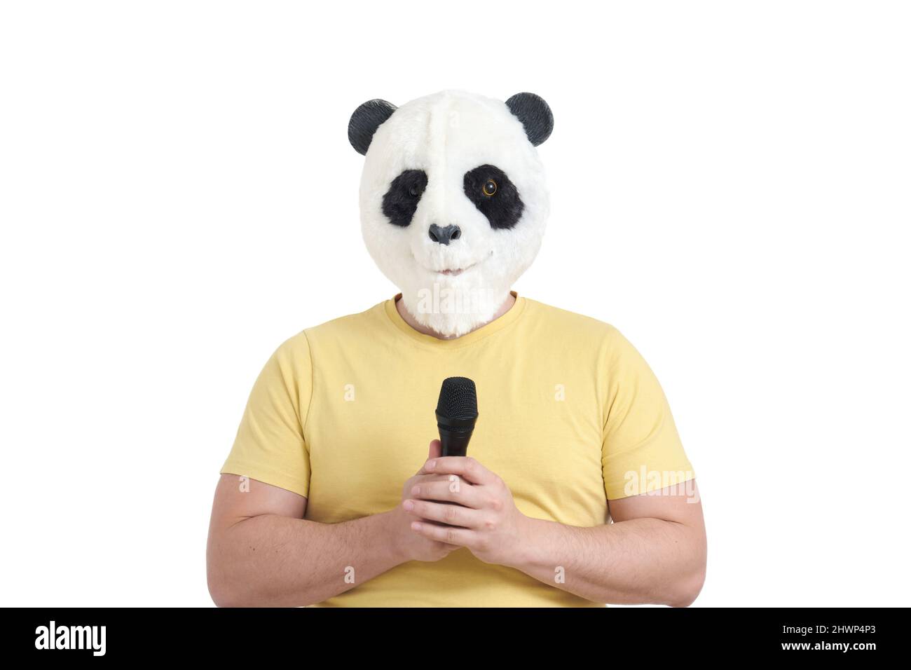 Man wearing a panda mask head holding a microphone isolated Stock Photo ...