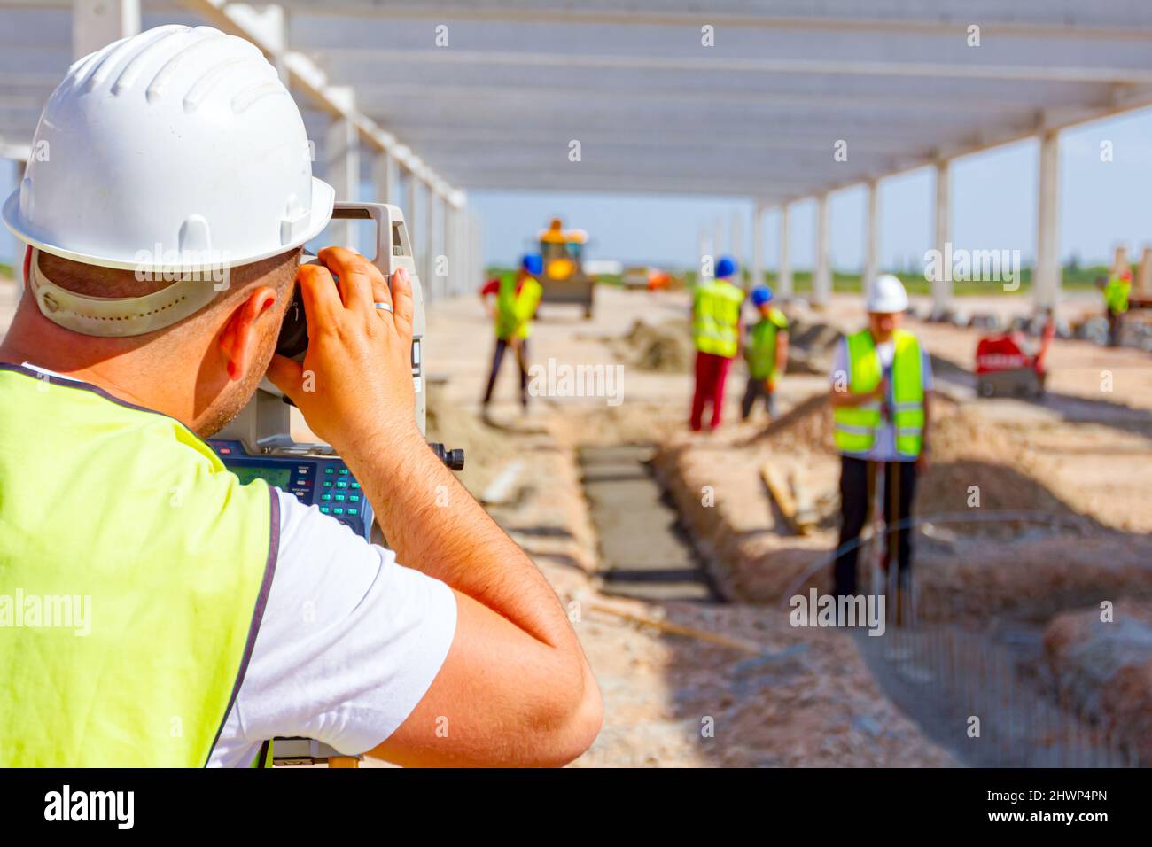 Surveyor engineer is measuring level on construction site. Surveyors ...