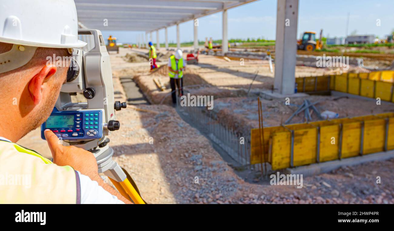 Surveyor engineer is measuring level on construction site. Surveyors ...