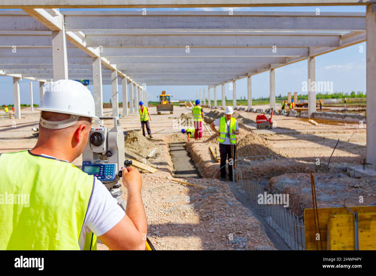 Surveyor engineer is measuring level on construction site. Surveyors ...