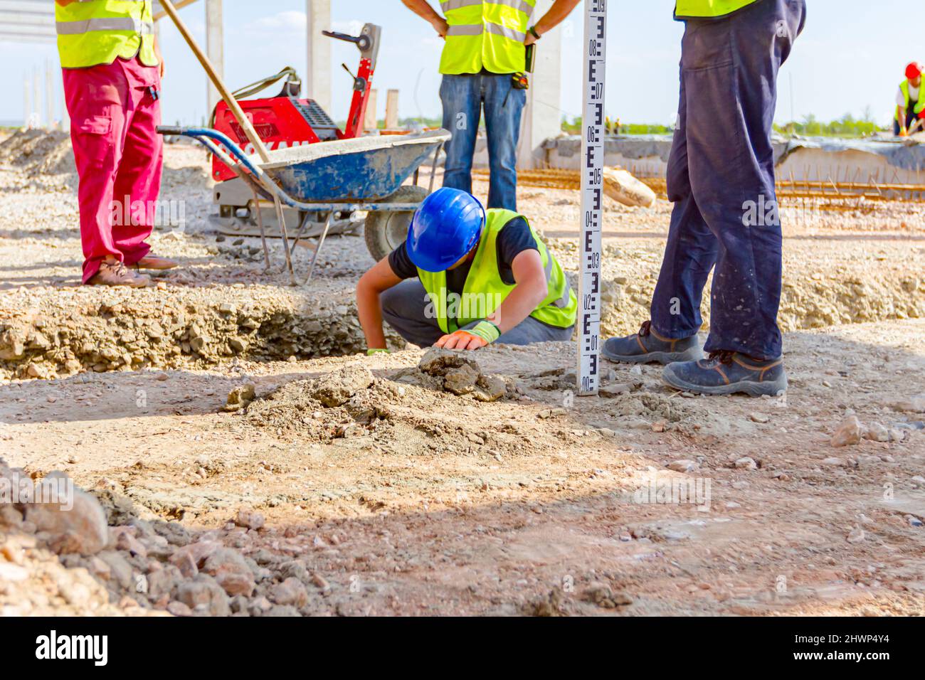 Construction worker is using tool to realign, correct measure or level ...
