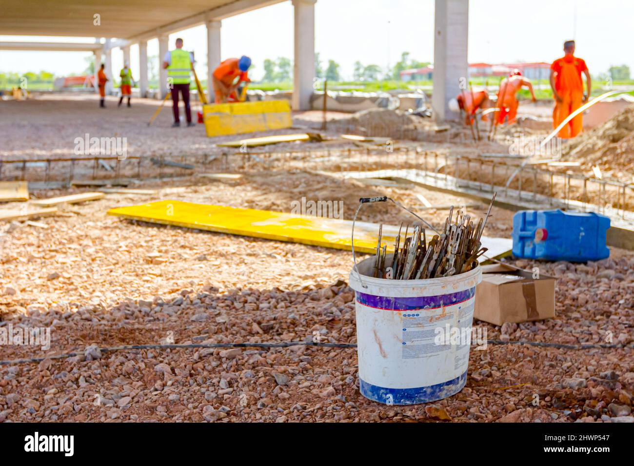 View on plastic bucket with equipment at construction site. Riggers ...