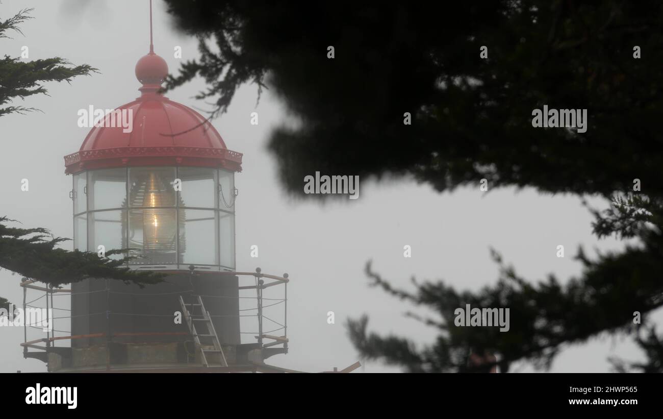 Point Pinos old historic lighthouse fresnel lens glowing, foggy rainy ...