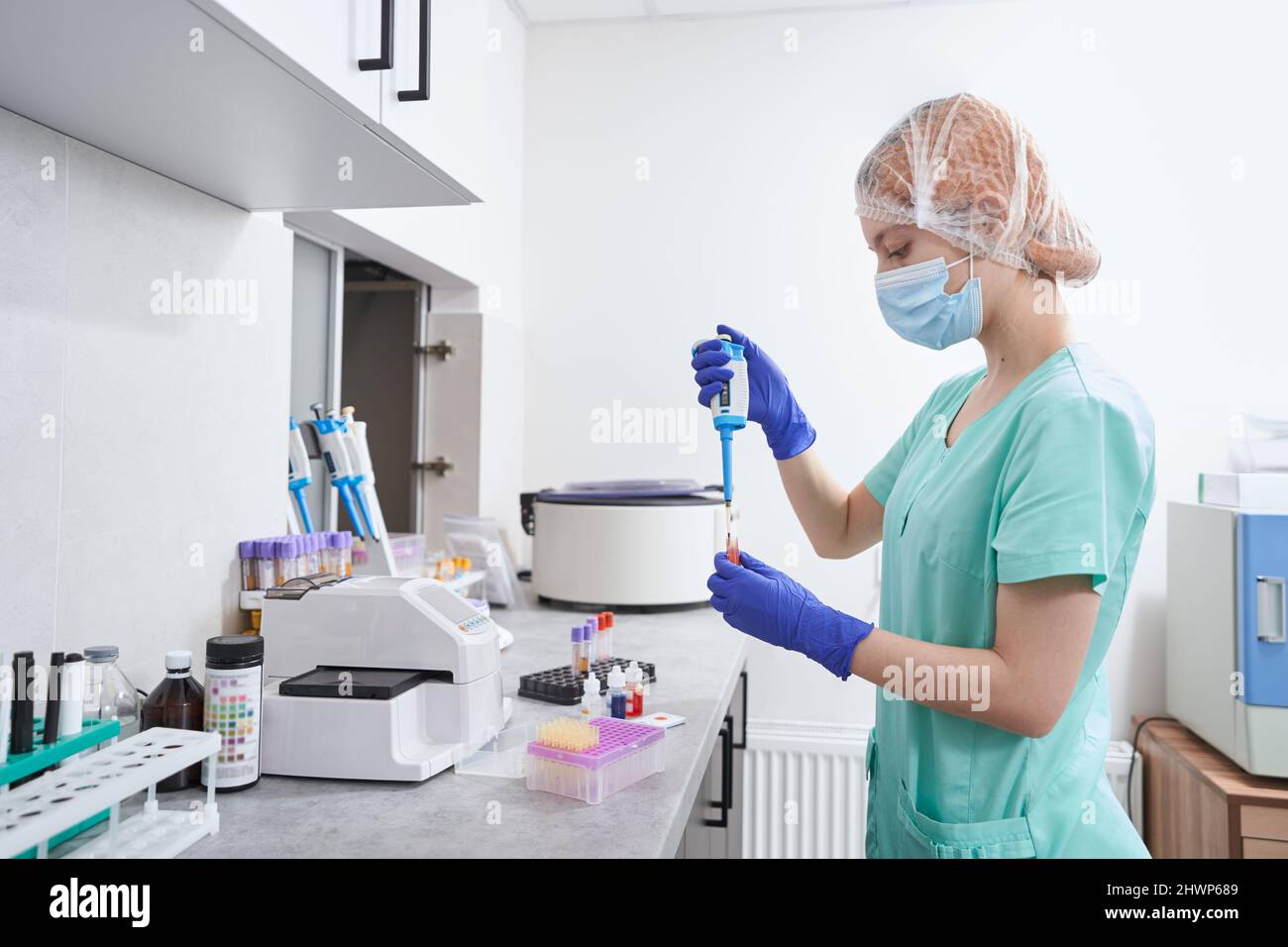 Woman taking liquid for research in laboratory Stock Photo - Alamy