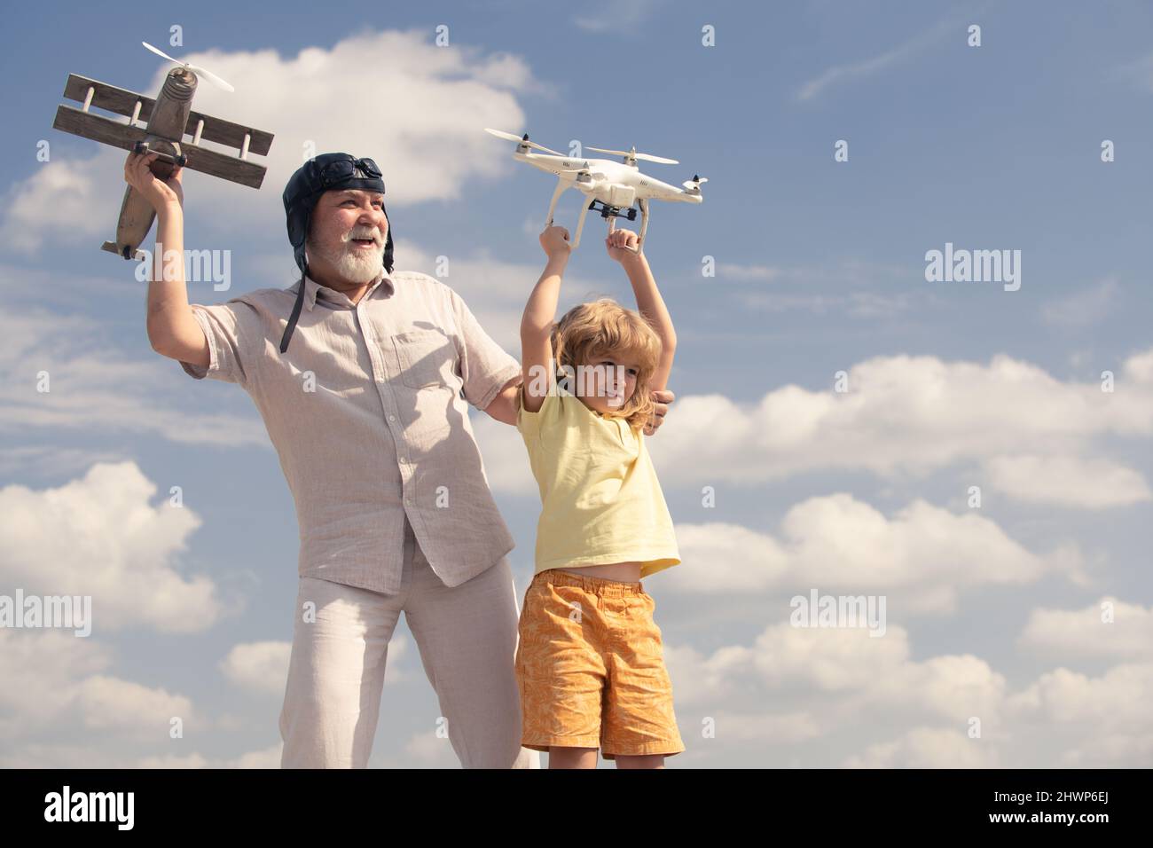 Grandfather and grandson hold plane and drone quadcopter. Child boy ...