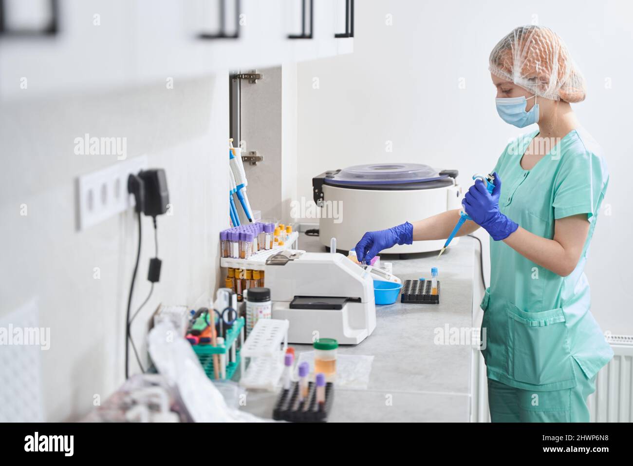 Female in medical suit working in laboratory Stock Photo - Alamy