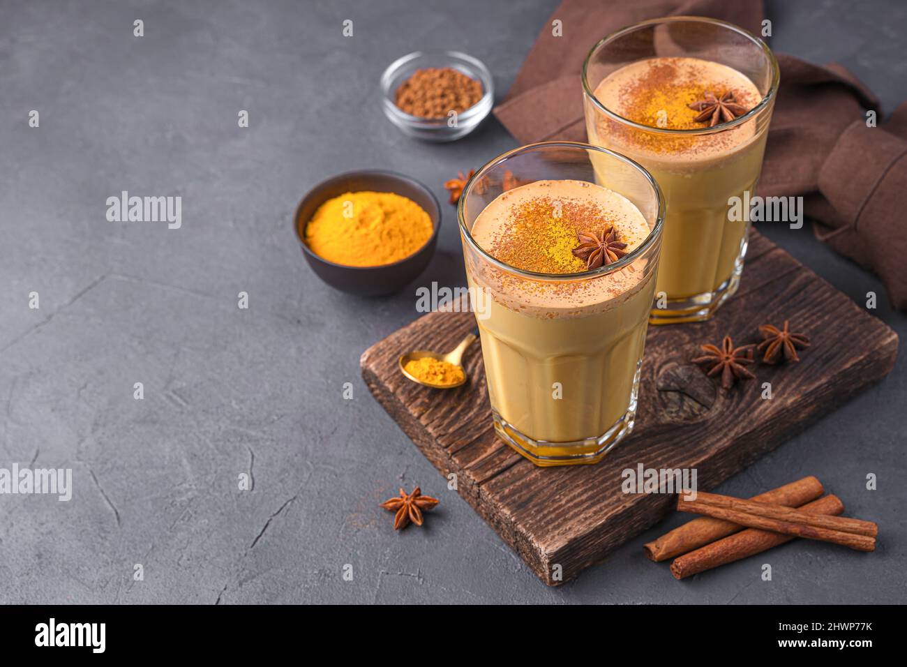 Cappuccino with Indian turmeric, anise and cinnamon on a dark ...