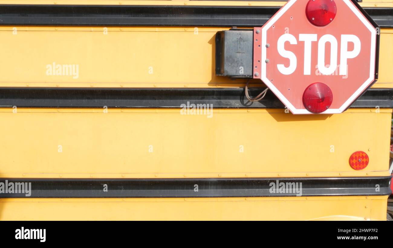 Red stop sign, yellow school bus in California, USA. Traffic warning on ...