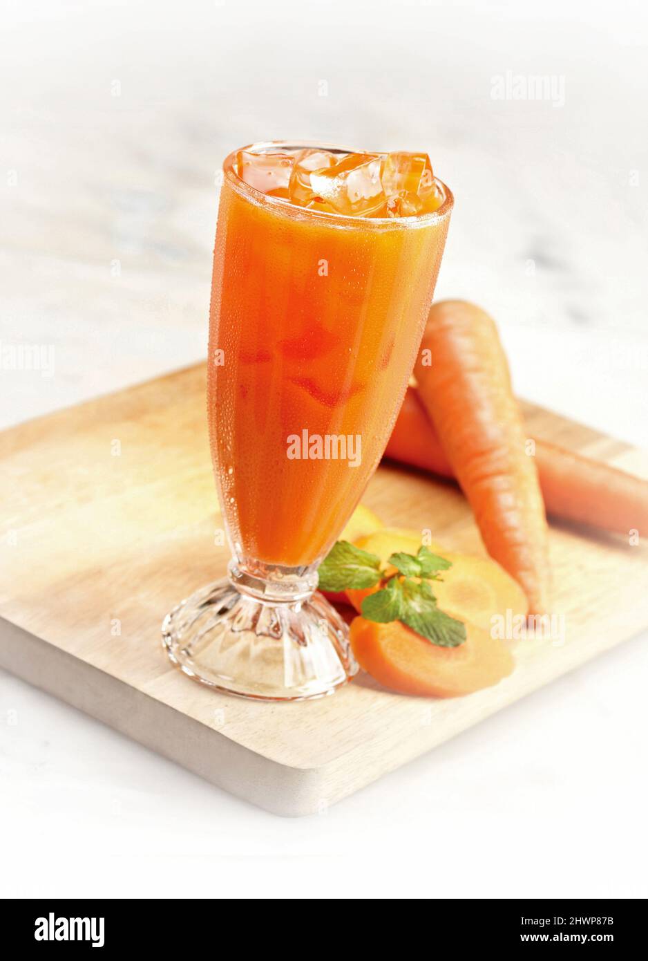 Glass of carrot juice on chopping board Stock Photo - Alamy