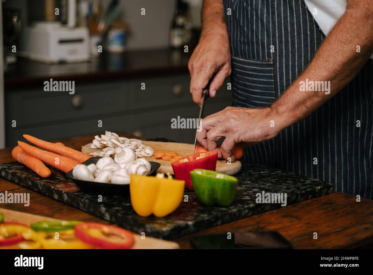 Chopping vegetables in kitchen person hi-res stock photography and ...
