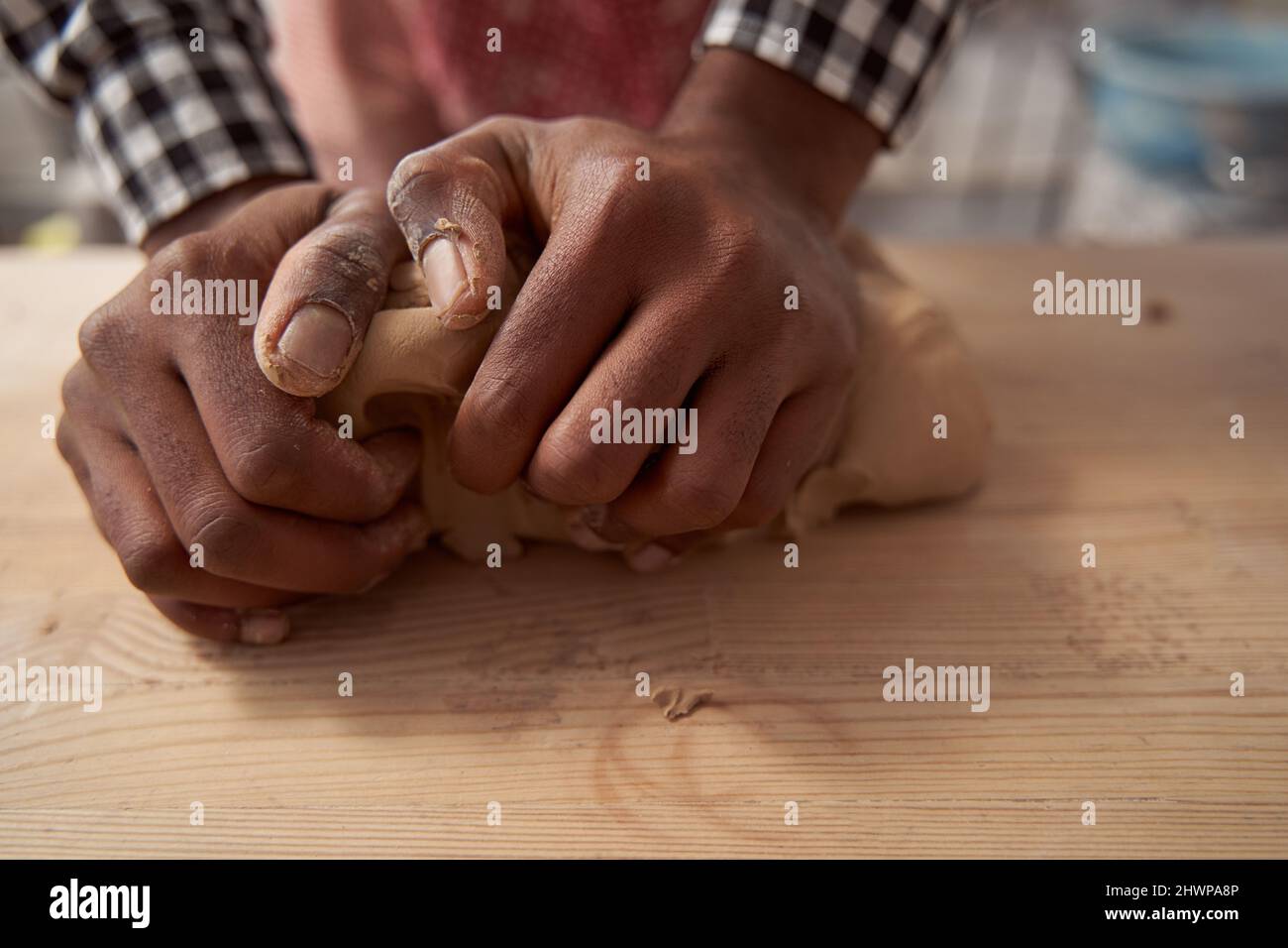 Craft artist removing air bubbles during wedging process Stock Photo ...