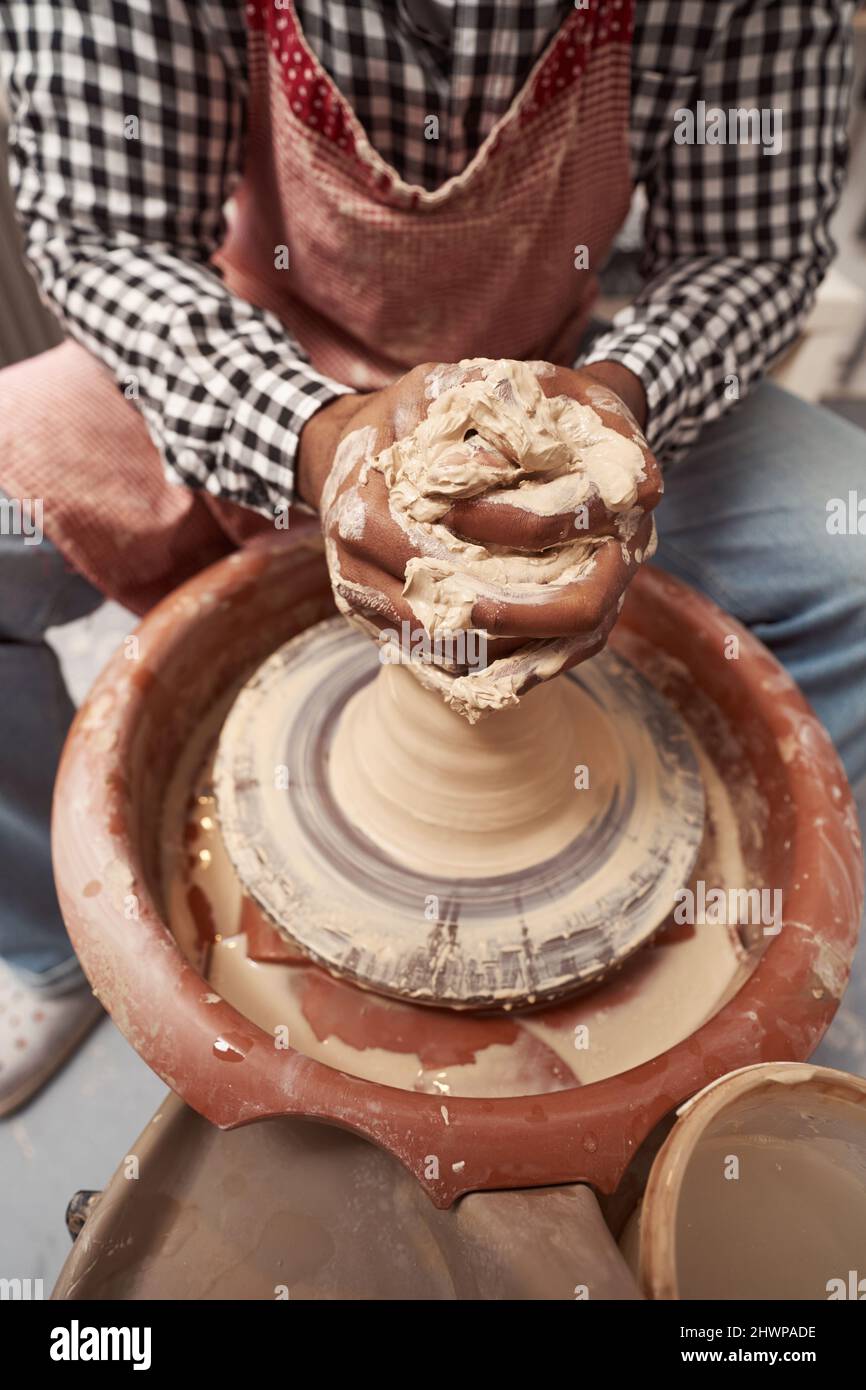Skilled African American potter shaping ceramic ware Stock Photo - Alamy