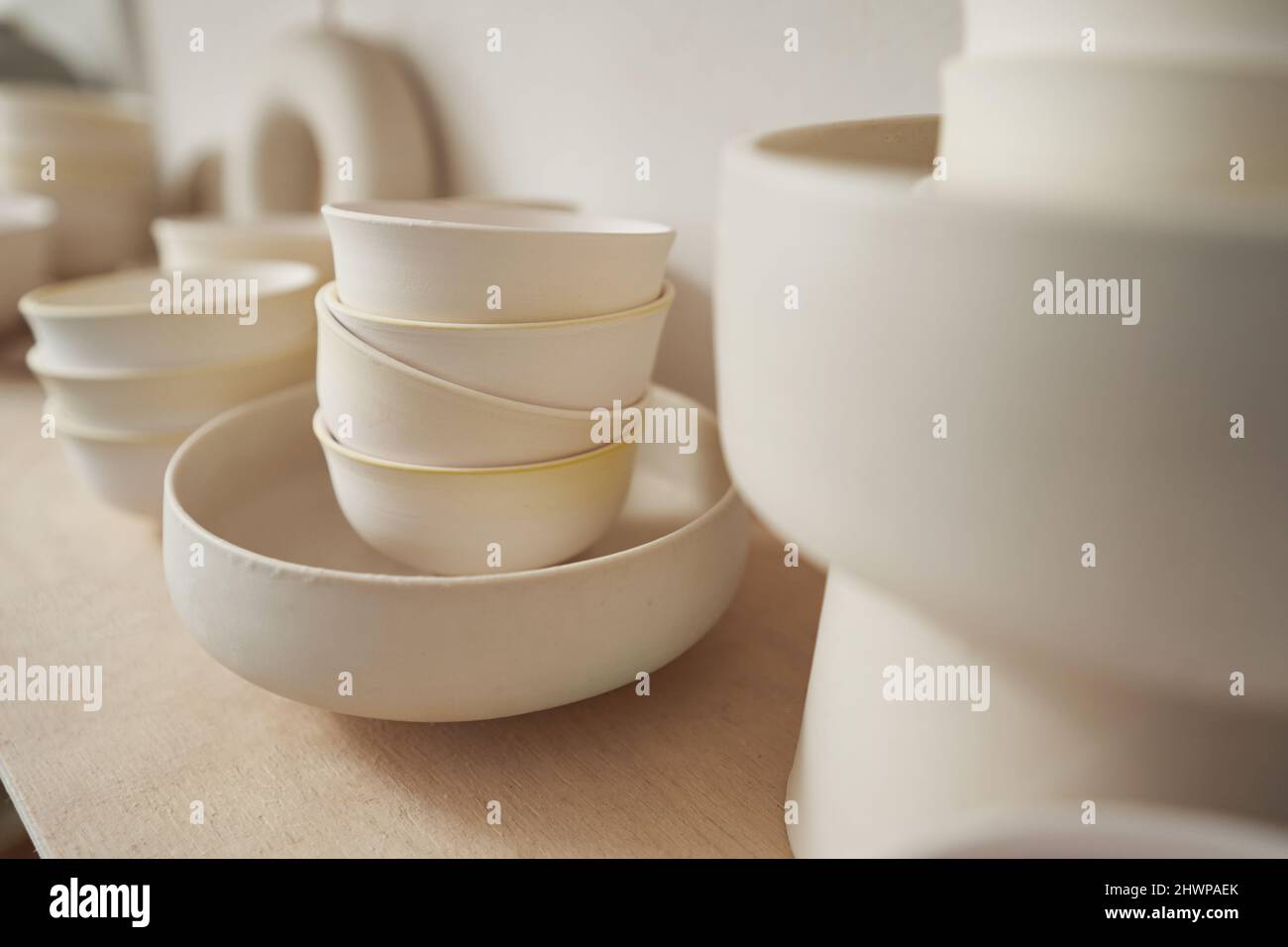 Round ceramic dish and teabowls in pottery studio Stock Photo - Alamy