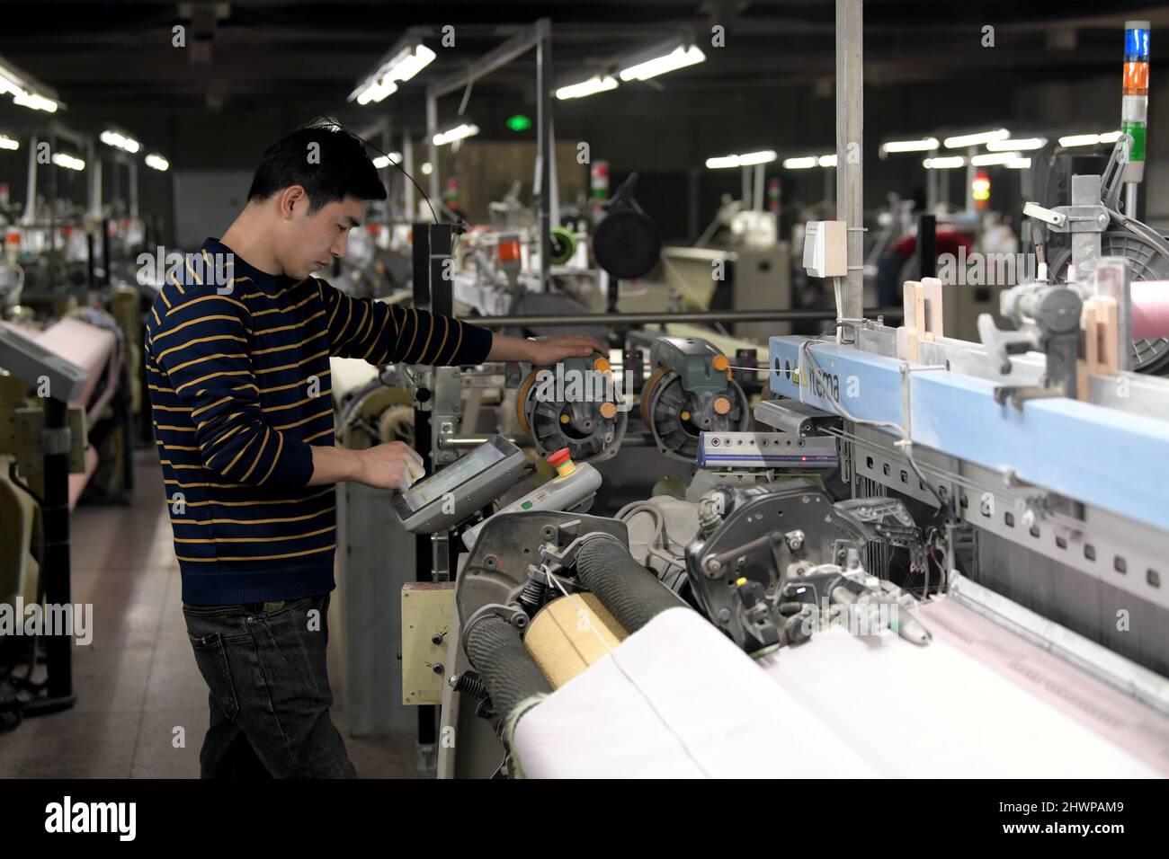 HAIAN, CHINA - MARCH 7, 2022 - An employee controls a imported high-end ...
