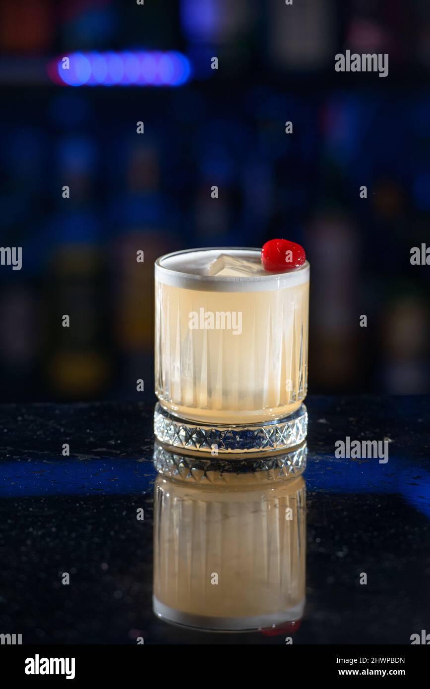 Yellow beige drink with ice and juice. raspberry topping Stock Photo ...