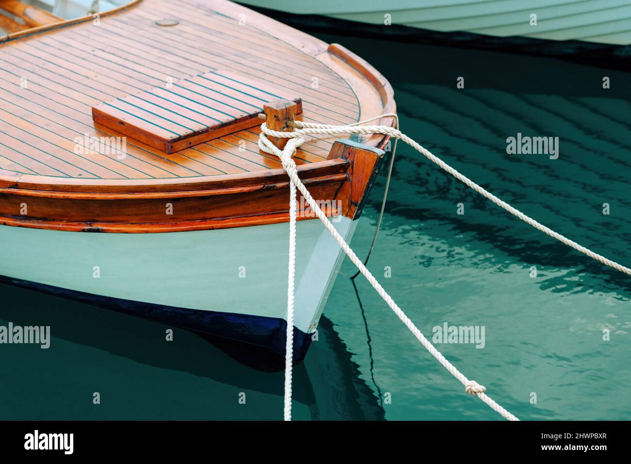 Wooden fishing boat bow in seaside marina, nautical vessel moored to a ...