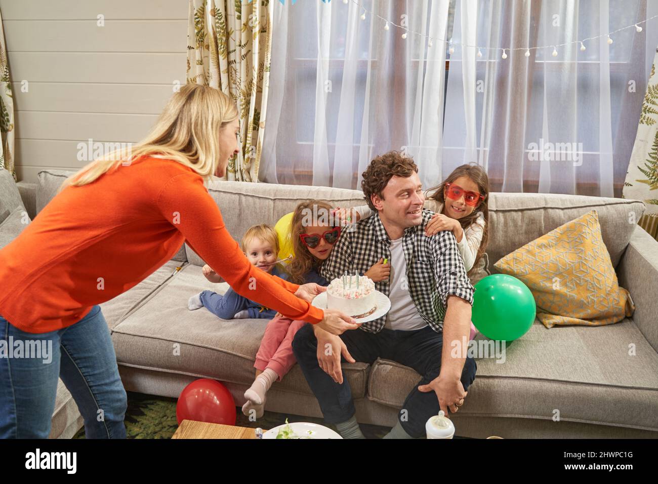 Happy girls at birthday party with parents Stock Photo - Alamy
