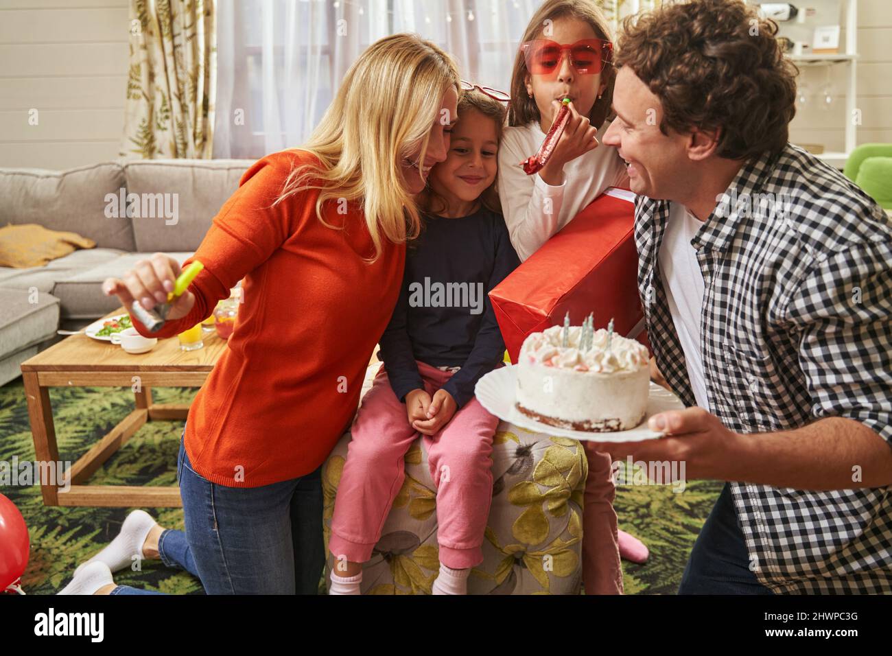 Joyful family having birthday party with cake Stock Photo - Alamy