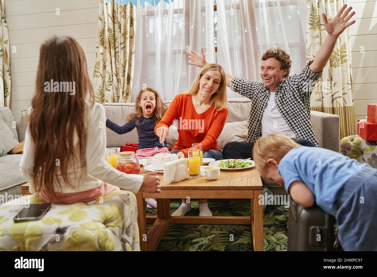 Happy children and parents having fun together Stock Photo - Alamy