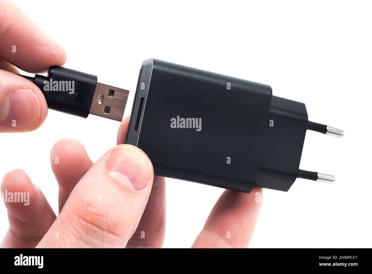 The man's hands hold the USB cable to connect to the adapter. USB cable ...