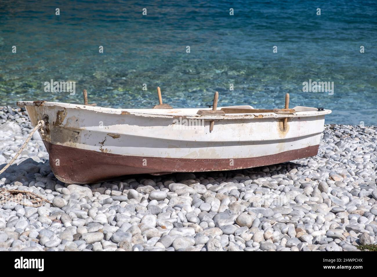 Fishing boat empty, wooden and rusty abandoned on pebble coast. Old ...