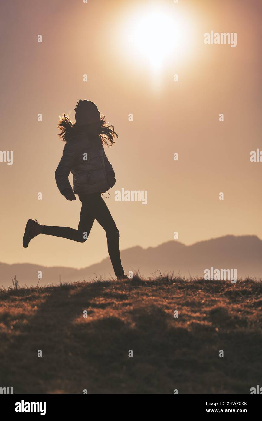 Running in the Meadows. A little girl in silhouette Stock Photo - Alamy