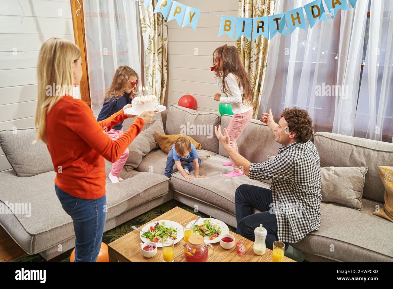Family celebrating birthday and having fun at home Stock Photo - Alamy