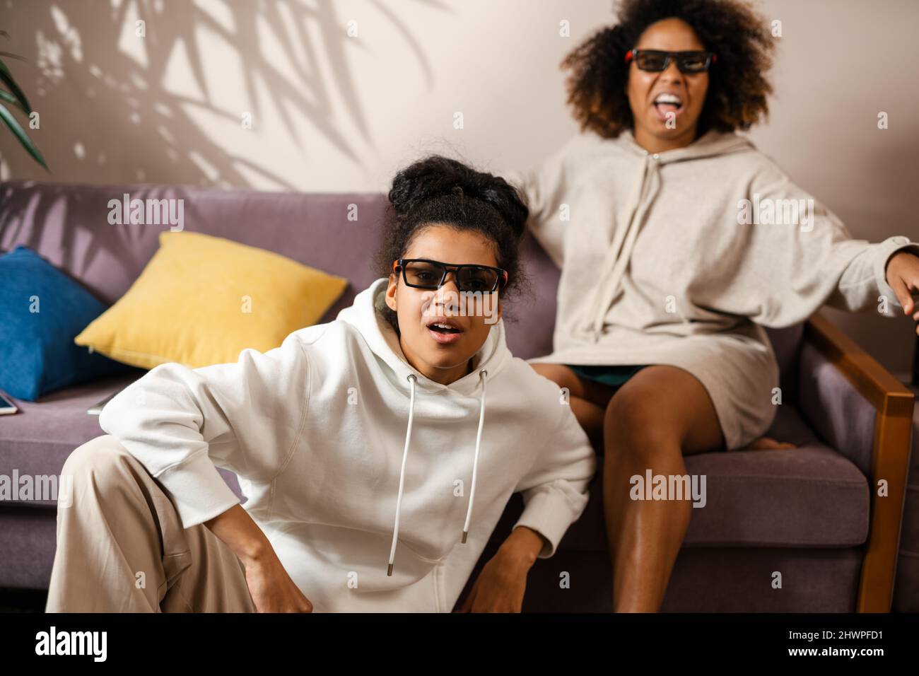 Shocked women sitting on sofa hi-res stock photography and images - Alamy