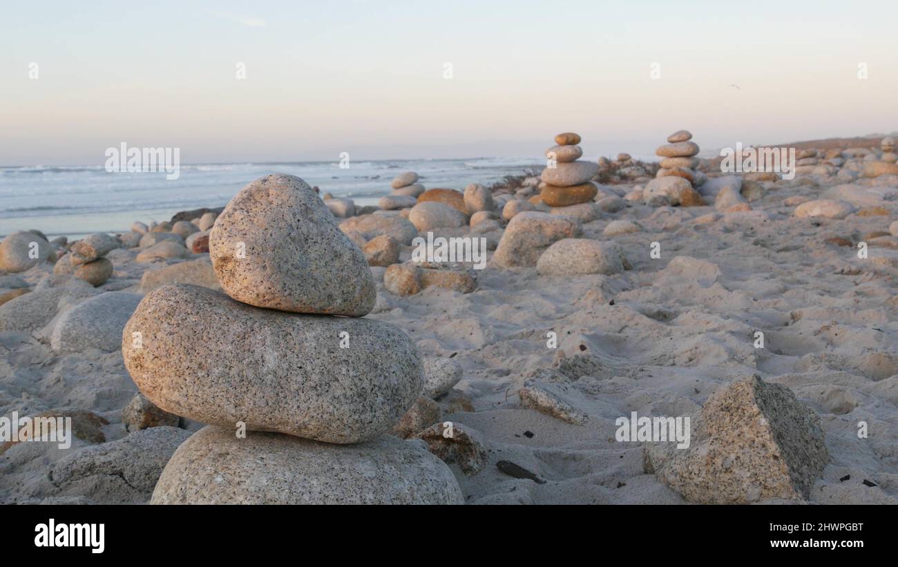 Rock balancing on pebble beach, Monterey 17-mile drive, California ...
