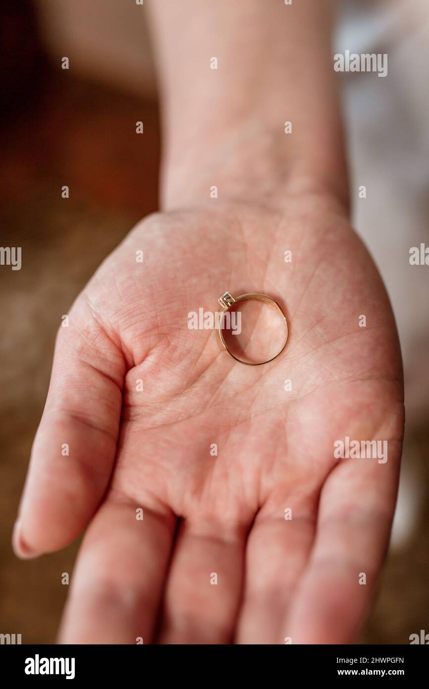 A pair of wedding gold rings in the hands of the bride. Wedding rings ...
