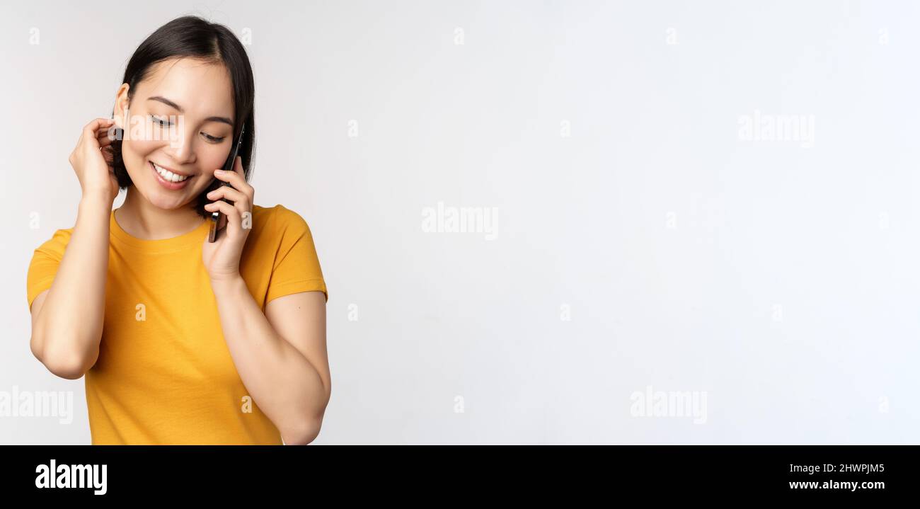 Romantic and cute asian girl answer phone call, talking on mobile ...