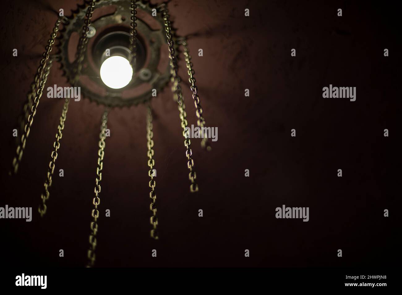 Lamp in bar. Interior decoration. Chandelier with chains. Unique light ...