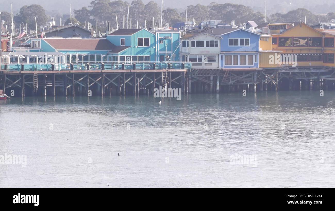 Colorful wooden houses on piles, pillars or pylons, ocean sea water ...