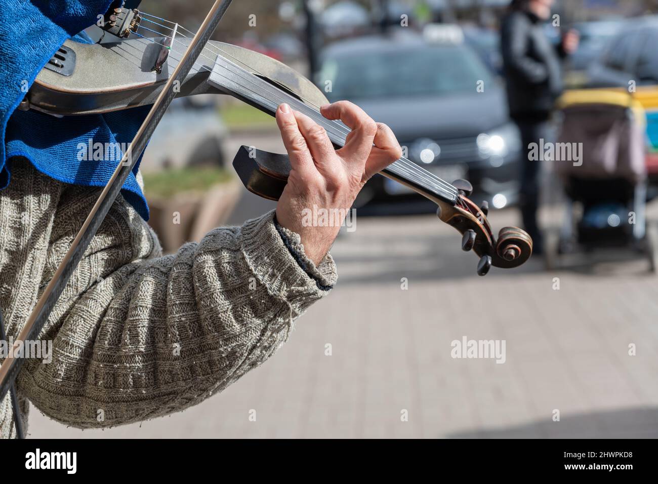 Close-up of a street musician's hands during a concert. Mature man ...