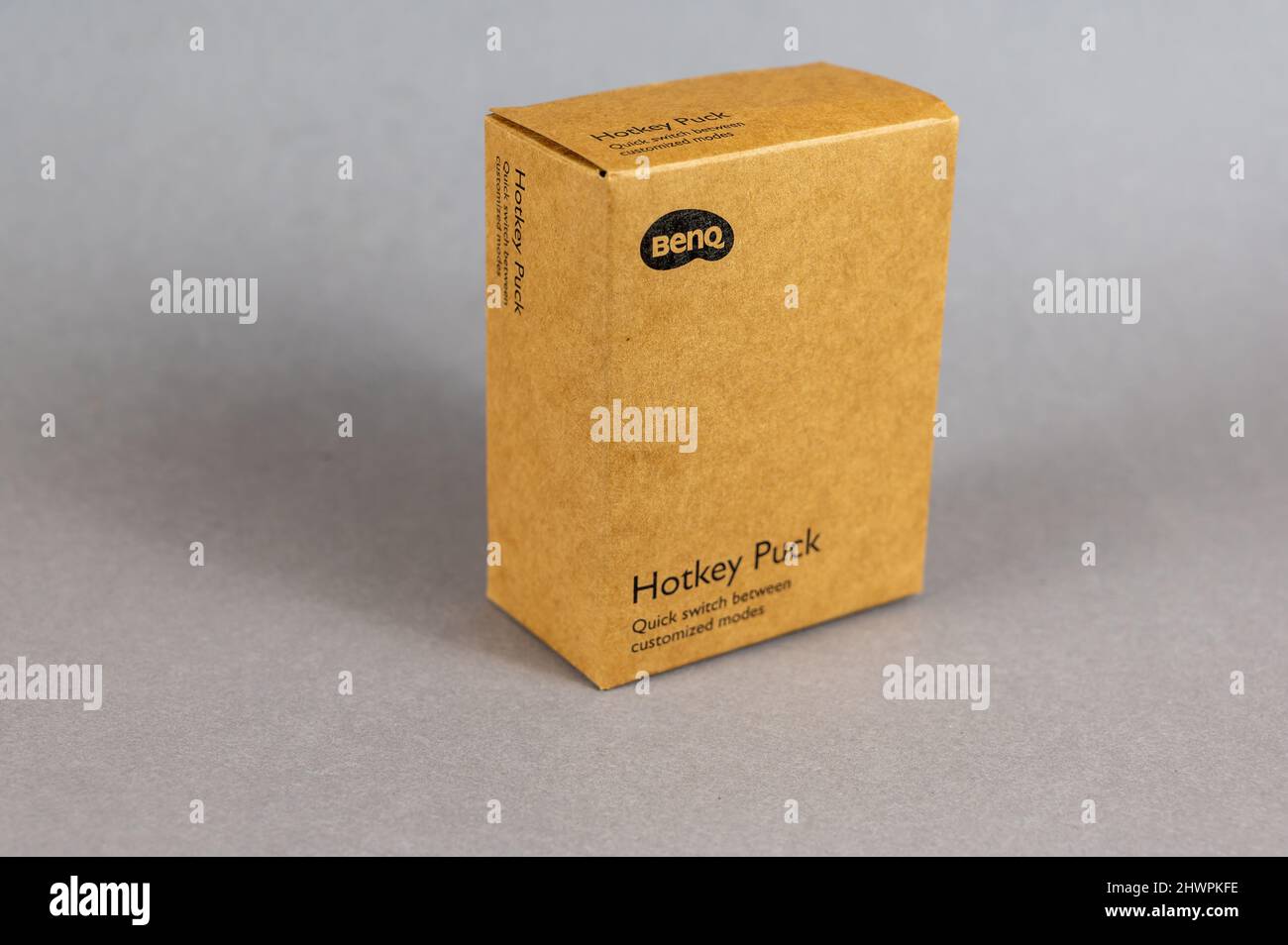 Brown cardboard box with Hotkey Puck for Benq monitor on a gray ...