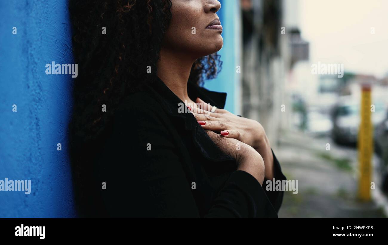 A black woman praying to God having HOPE and FAITH during hard times ...