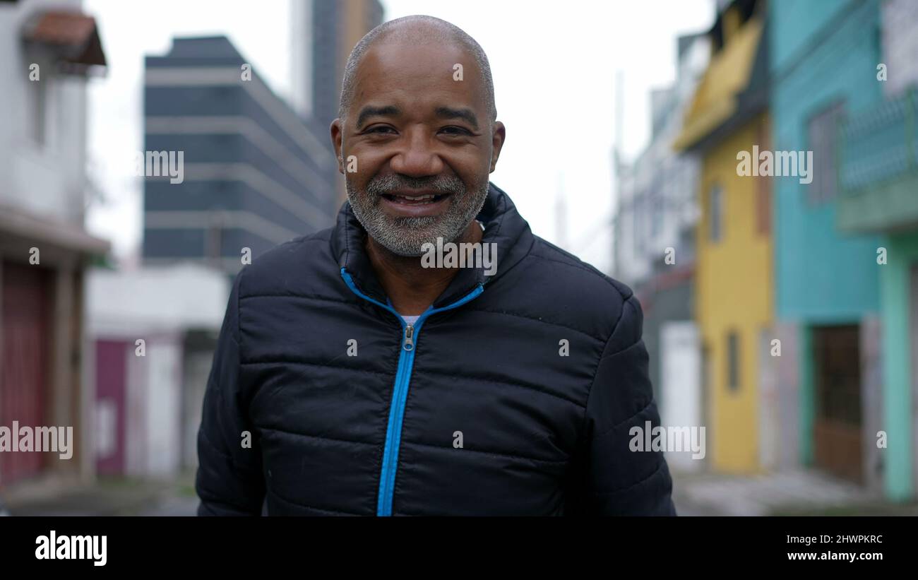 A Brazilian black person walking forward outside in urban street Stock ...