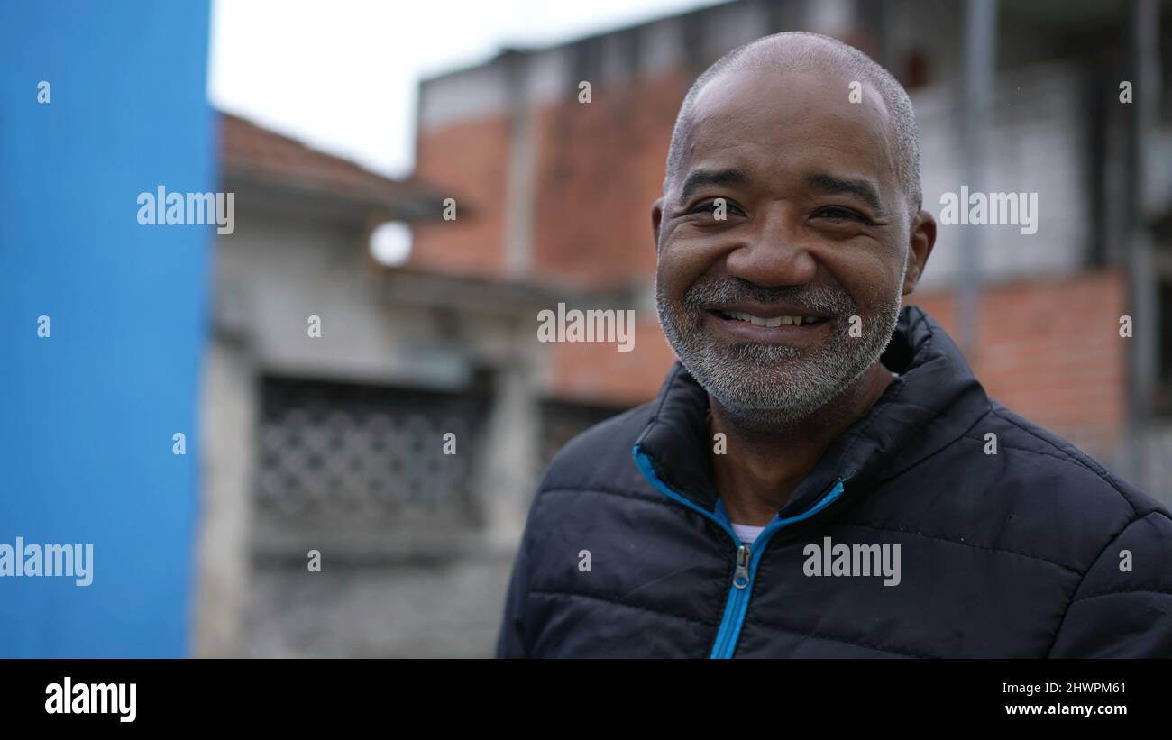 A senior African American person walking outside in street portrait ...