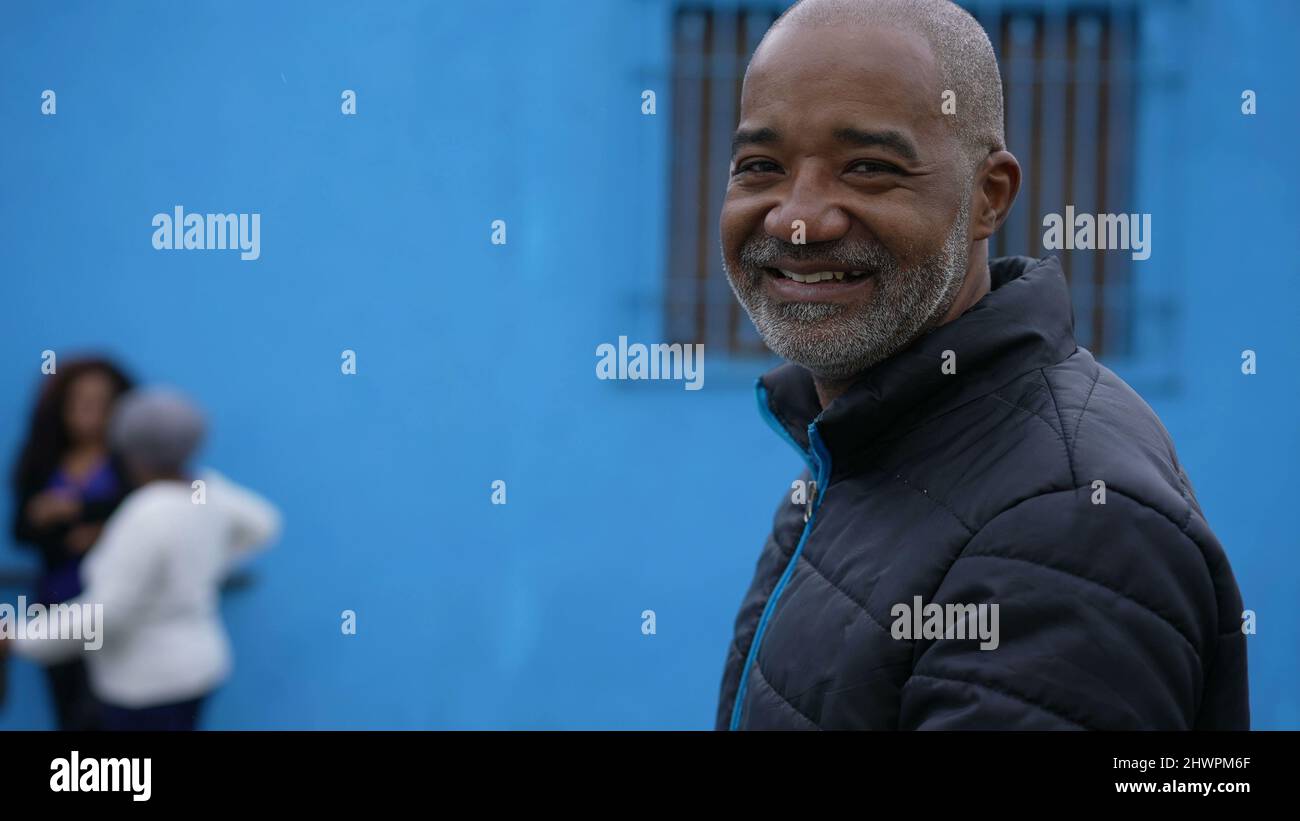 A senior African American person walking outside in street portrait ...