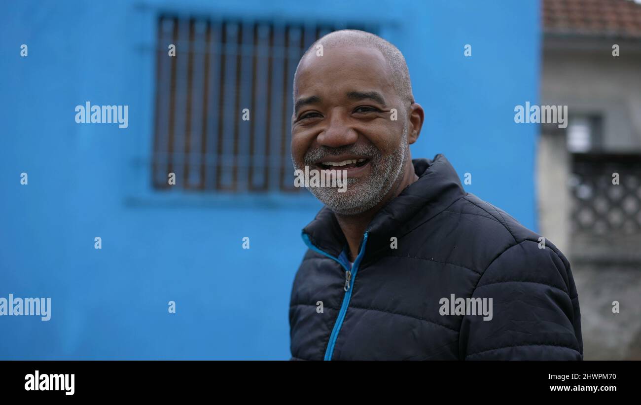 A senior African American person walking outside in street portrait ...